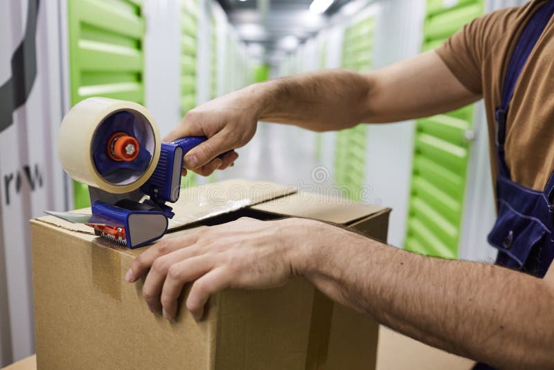 Man Sealing the Box with Tape Stock Photo - Image of warehouse ...