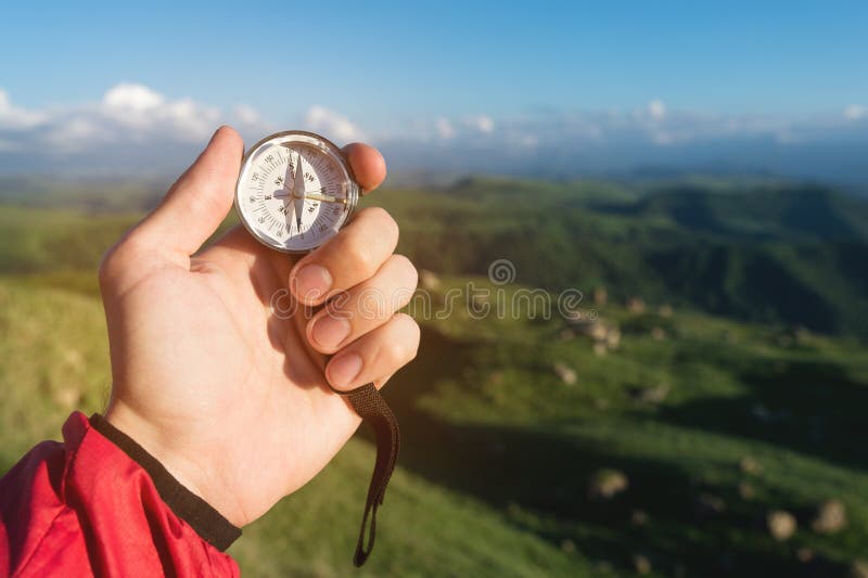 Man Searching Direction with a Compass in His Hand in the Summer ...