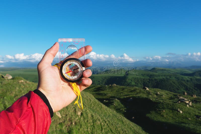Man Searching Direction with a Compass in His Hand in the Summer ...