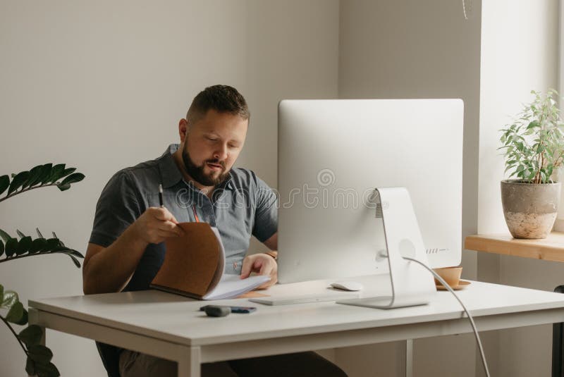 A Man is Searching for Information in a Notebook during a Video ...