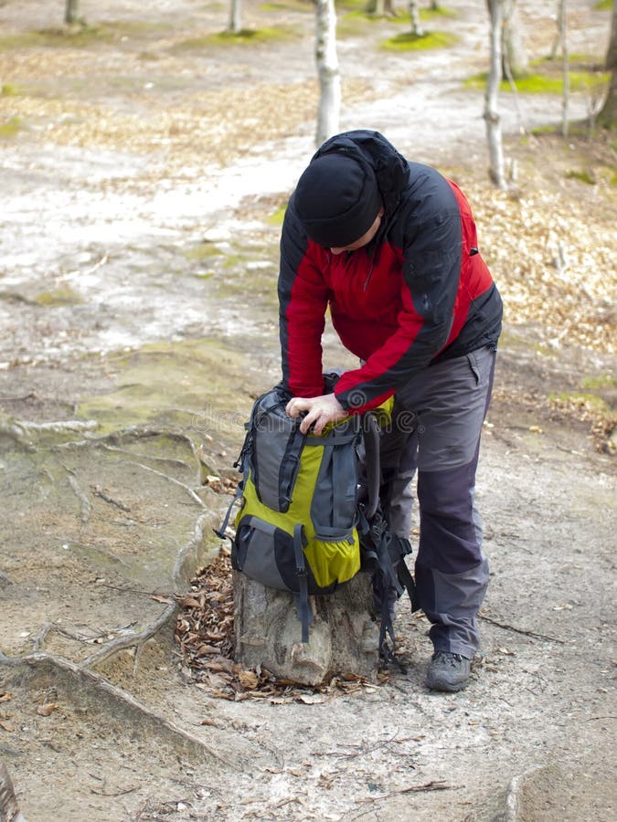 A Man Searching for Something in His Backpack. Stock Photo - Image of ...