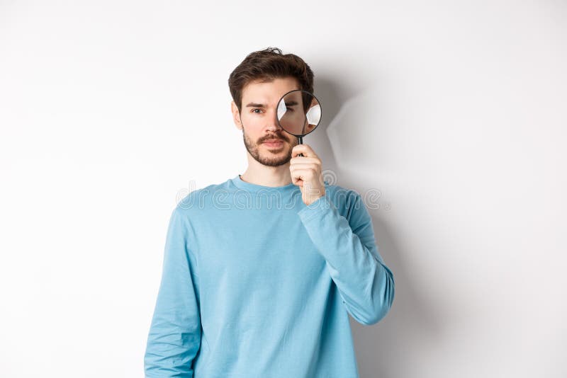 Man Searching for Something, Looking through Magnifying Glass at Camera ...