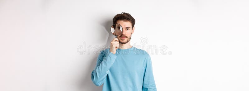 Man Searching for Something, Looking through Magnifying Glass at Camera ...