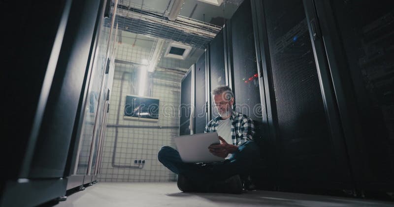 Man sitting in server room stock footage. Video of desktop - 319111958