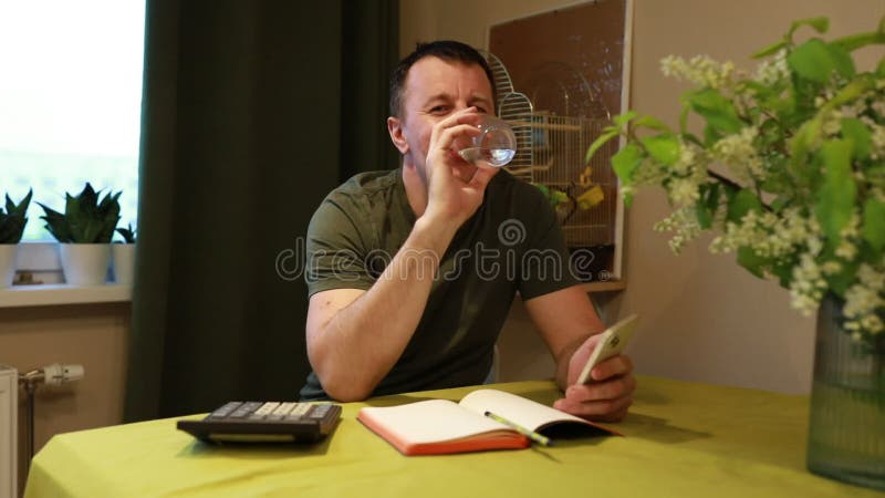 Man Sitting at Table with Book and Calculator Stock Video - Video of ...