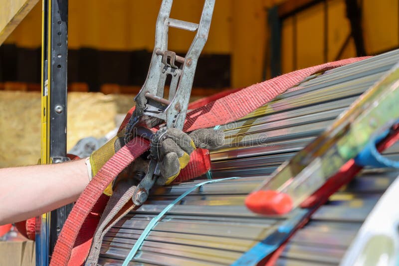 A Man Secures a Load with a Lashing Strap Stock Photo - Image of ...