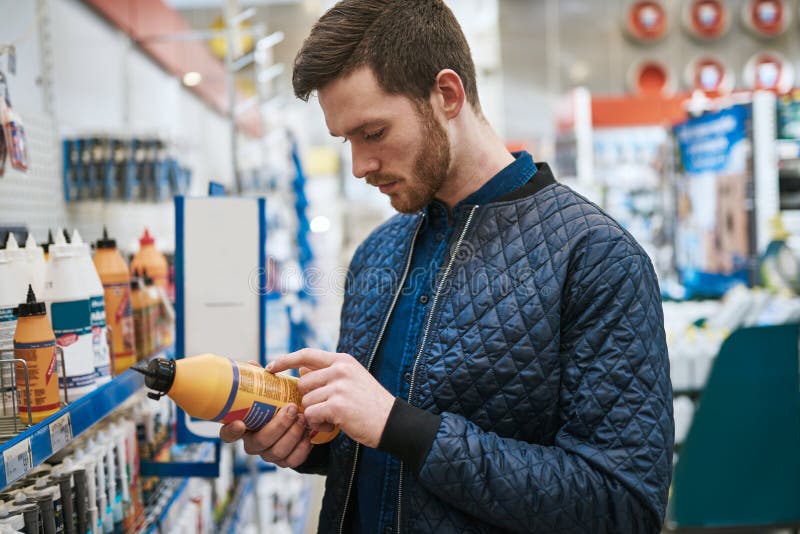 Man Selecting a Product in a Hardware Store Stock Photo - Image of ...