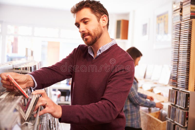 Man and Woman Working Behind the Counter at a Record Shop Stock Image ...