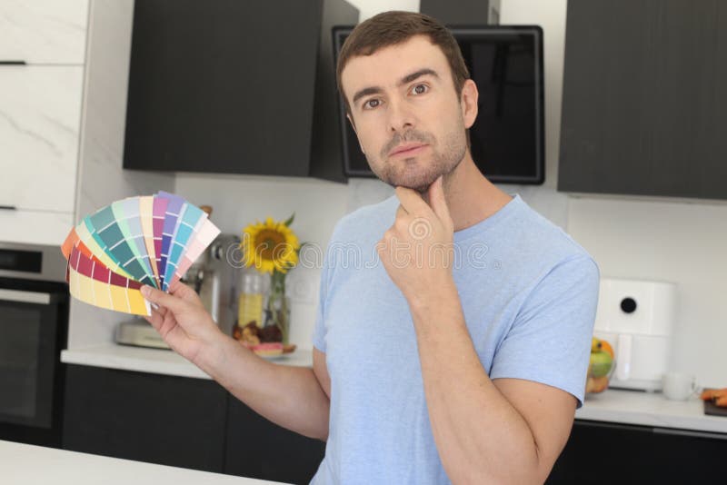 Man Selecting the Right Color for a Home Wall Stock Photo - Image of ...