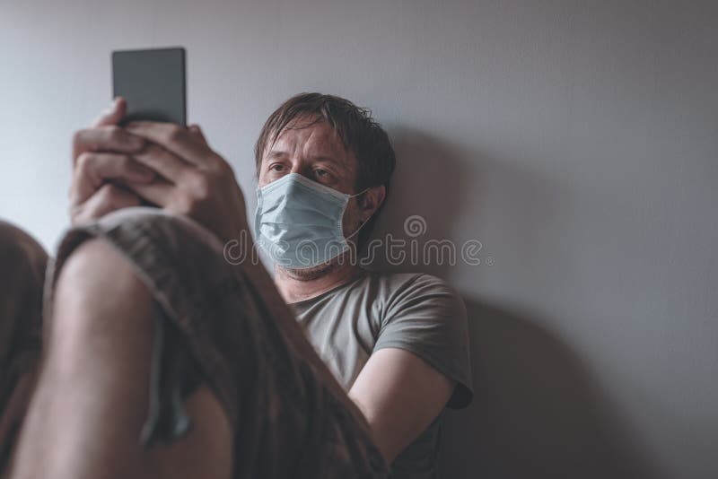 Man in Self-isolation during Virus Outbreak Using Mobile Phone Stock ...