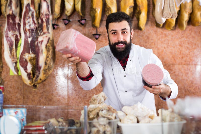 Man seller in butcher shop stock photo. Image of work - 234562648