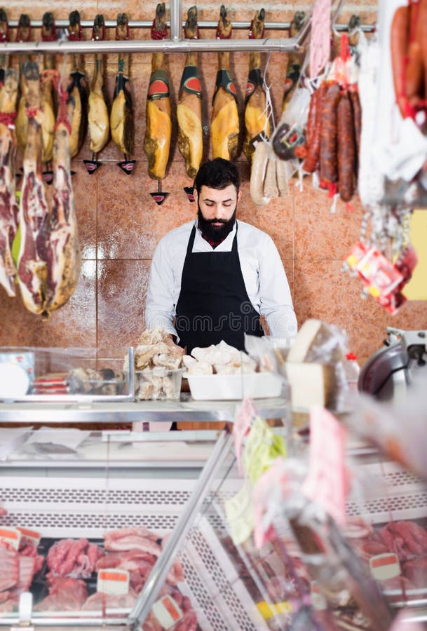 Man seller in butcher shop stock image. Image of offer - 234565861