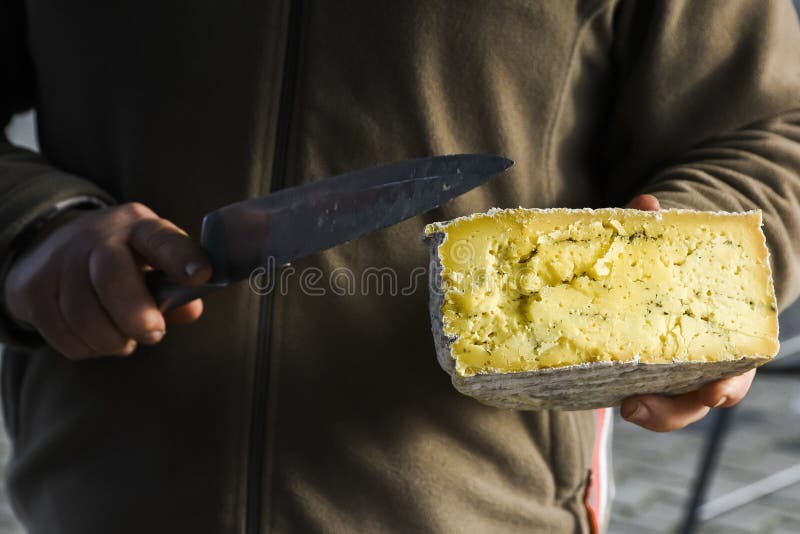 A Man Selling Cheese in the Market and Cutting Off a Piece Stock Image ...