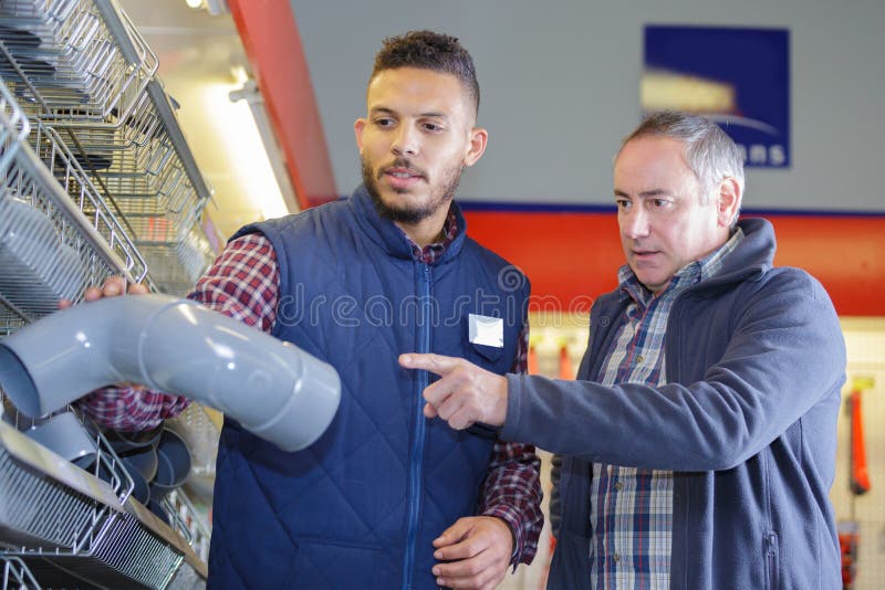 Man selling plastic pipes stock photo. Image of plumber - 117487610