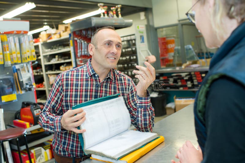 Man Selling Something To Customer in Warehouse Stock Photo - Image of ...