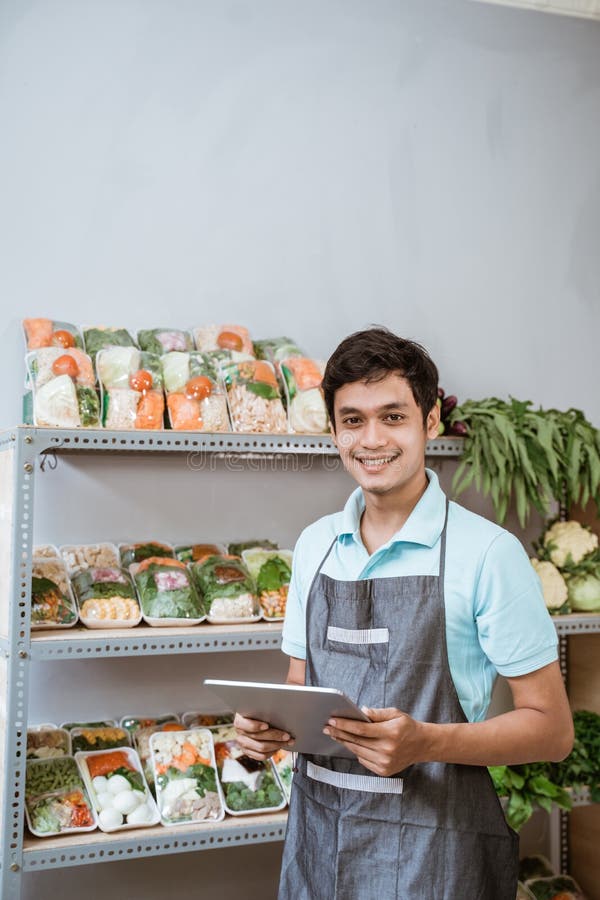 Man Selling Vegetables Counting Vegetables Using a Digital Tablet Stock ...