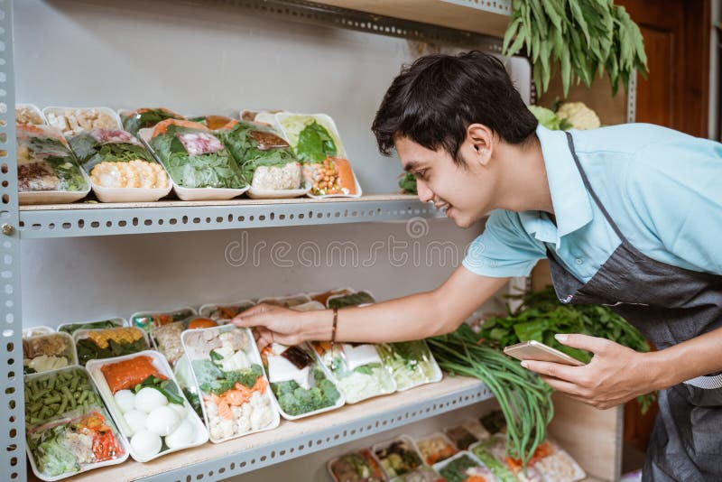 Man Selling Vegetables Counting Vegetables Using a Digital Tablet Stock ...