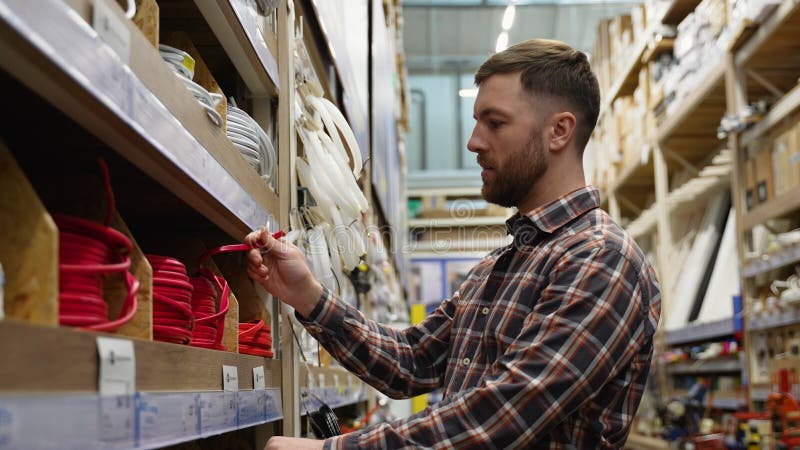 A Man Sells Electrical or Ethernet Cables in a Hardware Store Stock ...