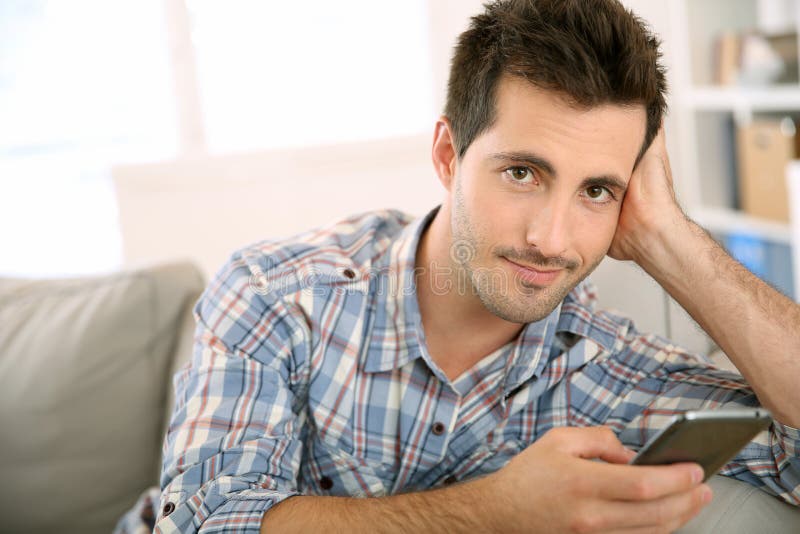 Man Sending Message with Smartphone from Sofa Stock Image - Image of ...