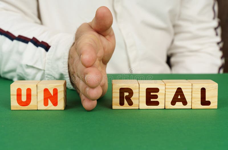 A Man Separates the Cubes with the Inscription - UN REAL Stock Image ...