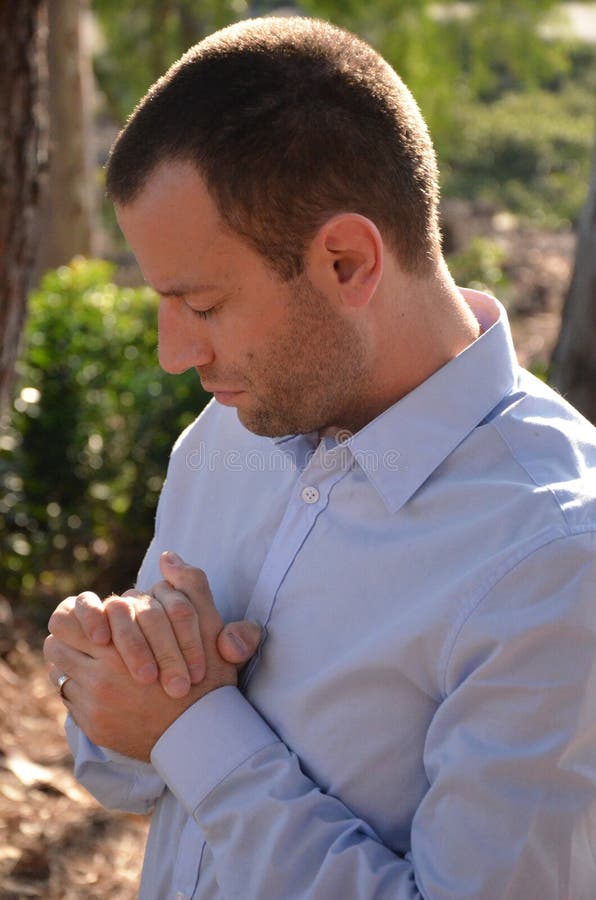 Man Standing and Praying on a Hillside. Stock Image - Image of young ...