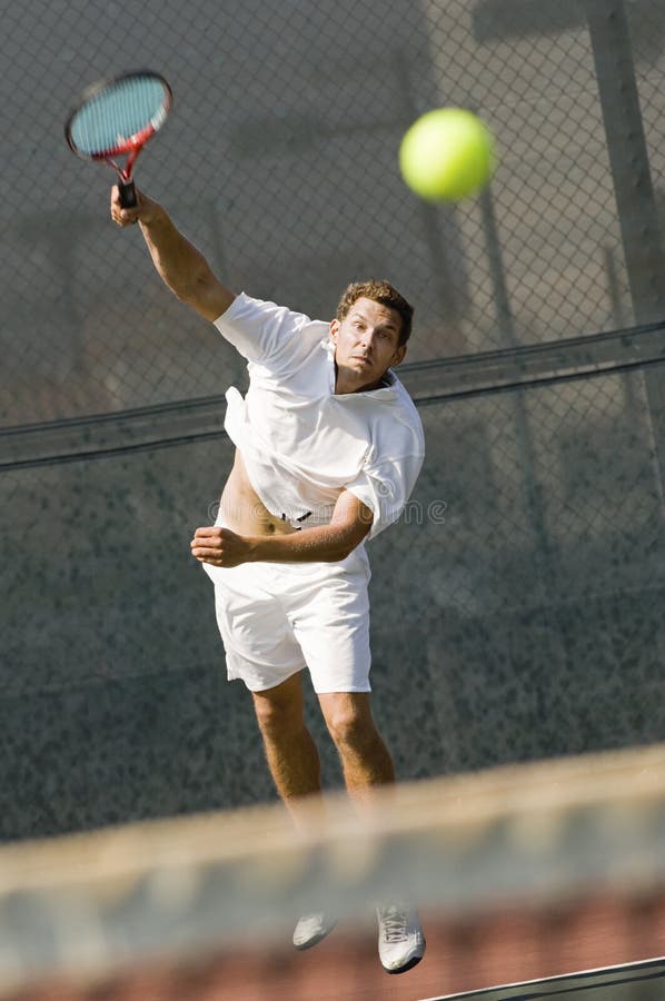 Man Serving Tennis Ball stock image. Image of playing - 13585375