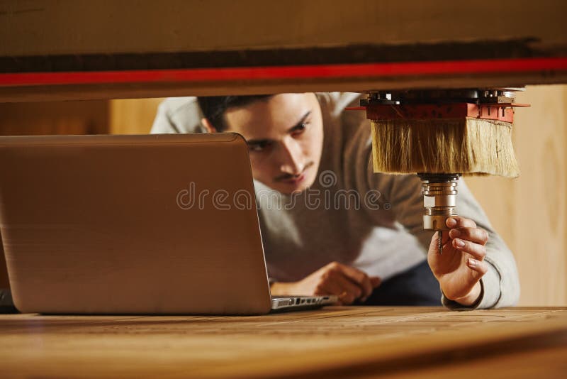 Man Sets the Cutter in Chuck for Cutting Wood. Machine with Computer ...