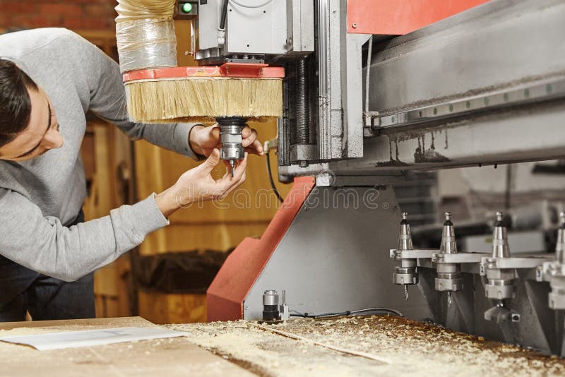 Man Sets the Cutter in the CNC Machine. Device with Numerical Control ...