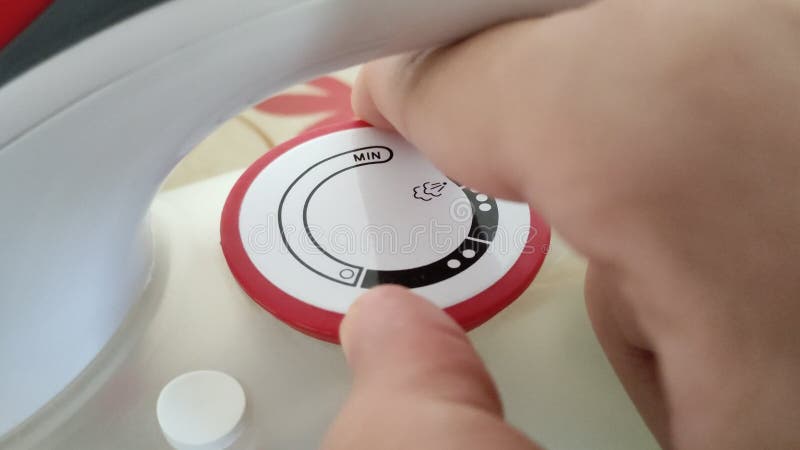 Man Setting Ironing Temperature. Electrical Iron Temperature Controler ...