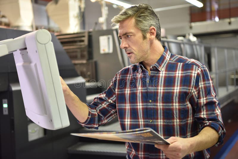 Man Setting Up a Printing Machine Stock Photo - Image of manufacturing ...