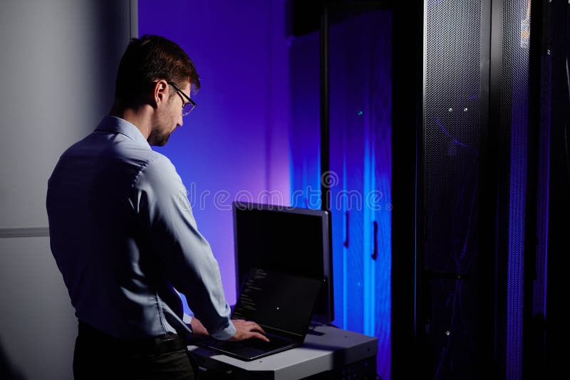 Man Setting Up Servers stock image. Image of technician - 250346581