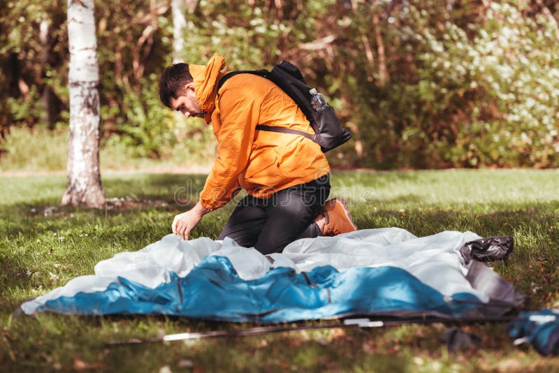 Man Setting Up Tent Outdoors Stock Image - Image of hispanic, traveler ...