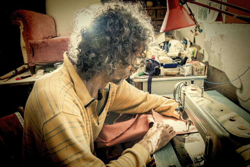 Man at the sewing machine stock photo. Image of repair - 41086692