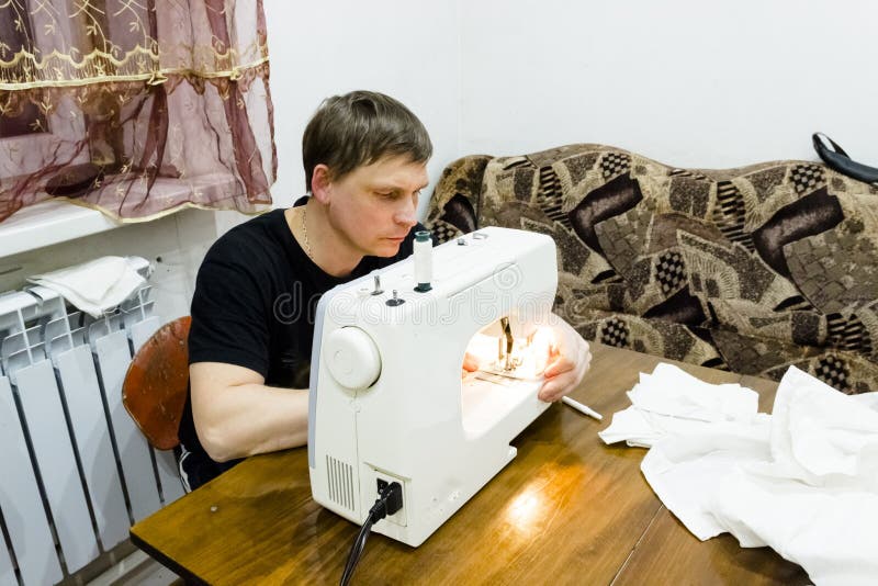 A Man Sews on a Sewing Machine Stock Photo - Image of designer ...