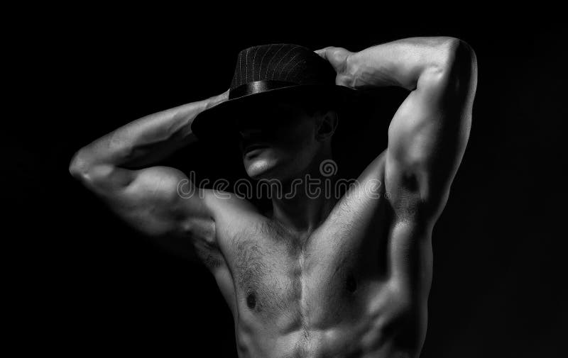 Man in Shadow. Young Man with Muscular Body in Hat with Bare Chest and ...