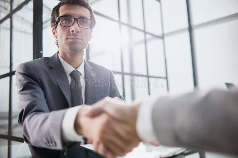 Man Shaking Hands with Partner Over Office Desk Stock Image - Image of ...