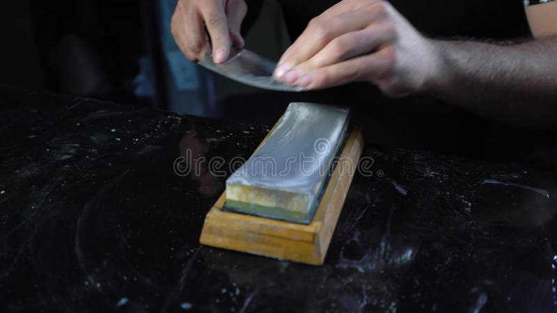 Man sharpening knife blade stock footage. Video of utensil - 354122410