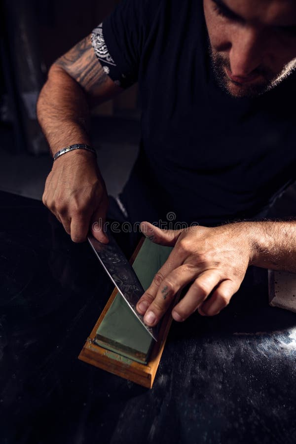 Man sharpening the knife stock image. Image of blade - 198747447
