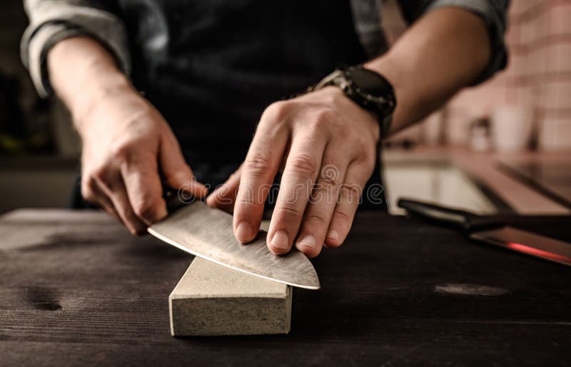 Man Sharpening a Knife with Whetstone Stock Photo - Image of butcher ...