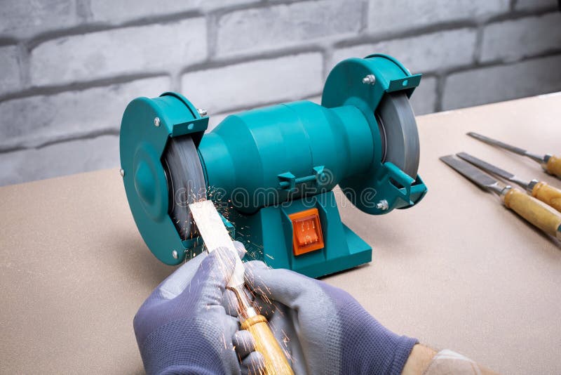 Man Sharpening Work Tool, Chisel on Grinder in Workshop. Stock Image ...