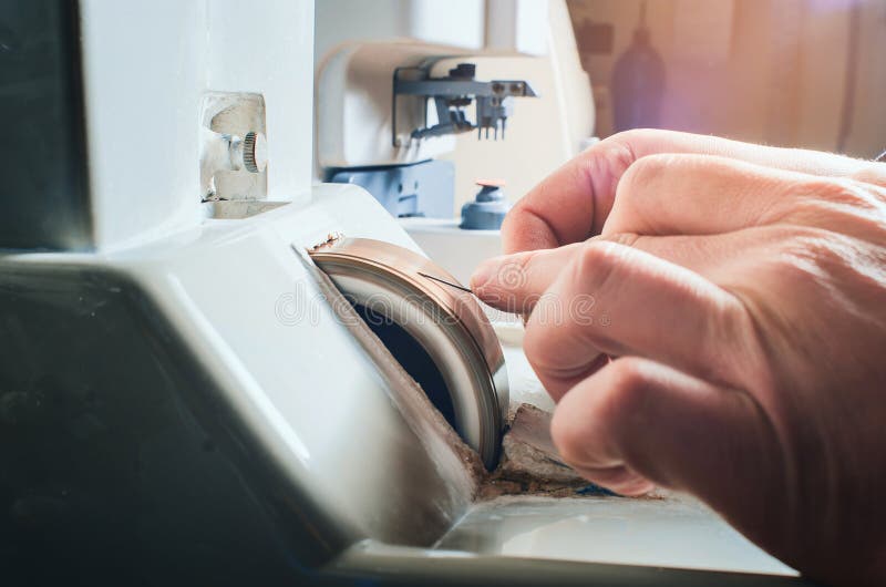 Man Sharpens a Metal Needle on a Grinding Wheel. Close-up of the Master ...