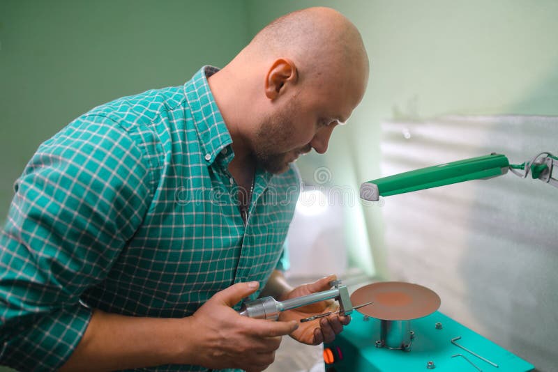 Master Sharpens Scissors on Special Equipment for Sharpening Tool Stock ...