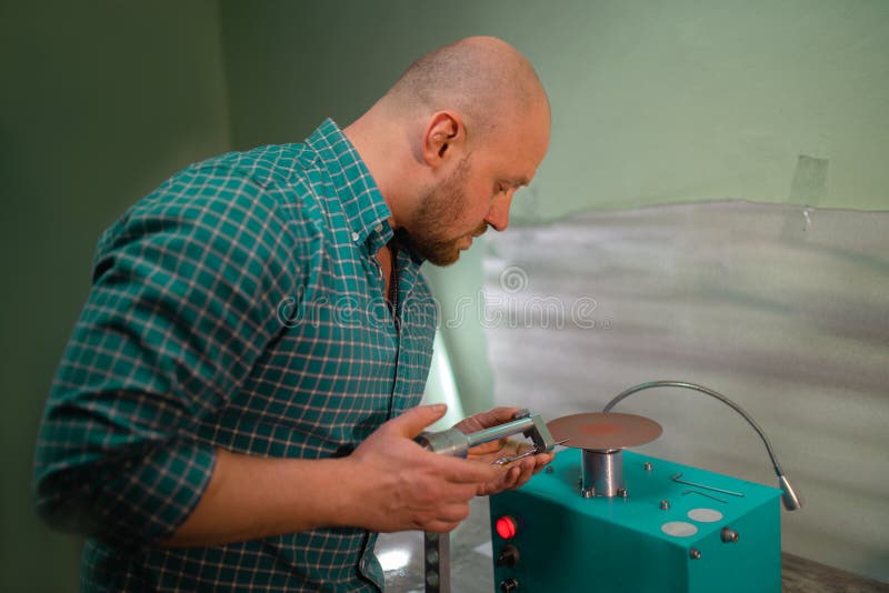 Master Sharpens Scissors on Special Equipment for Sharpening Tool Stock ...