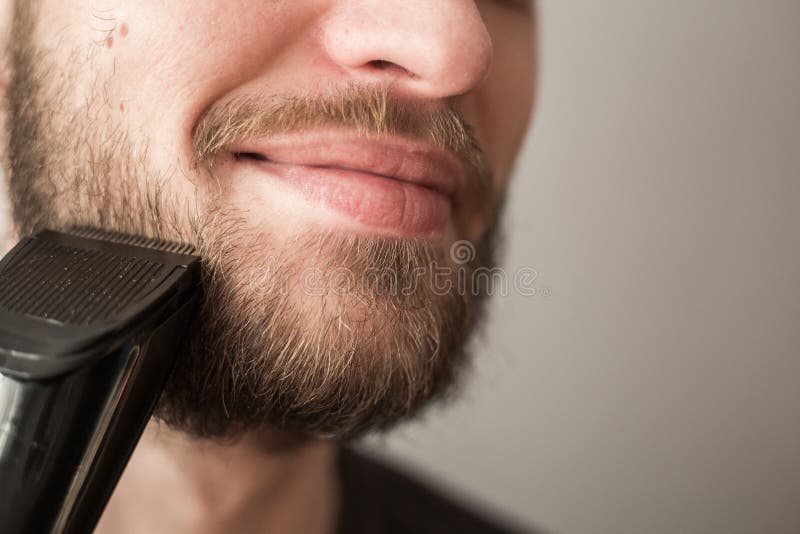 A Man Shaves His Beard with a Trimmer Stock Photo - Image of trimmer ... A Man Shaves His Beard with a Trimmer Stock Photo - Image of trimmer ...