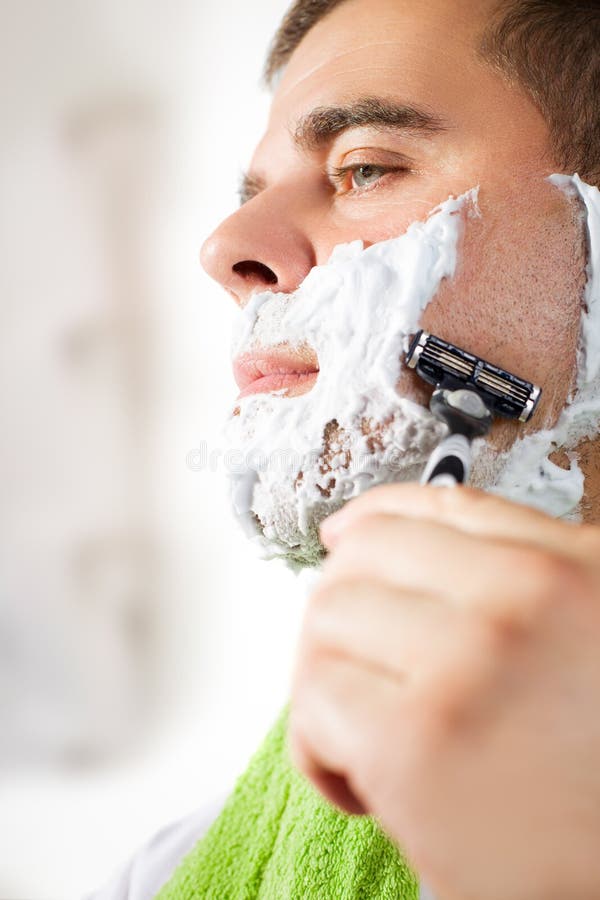 Man shaves his face stock photo. Image of shave, body - 61117338