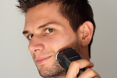 Man Shaving Face with Electric Razor Stock Photo - Image of eyes ...