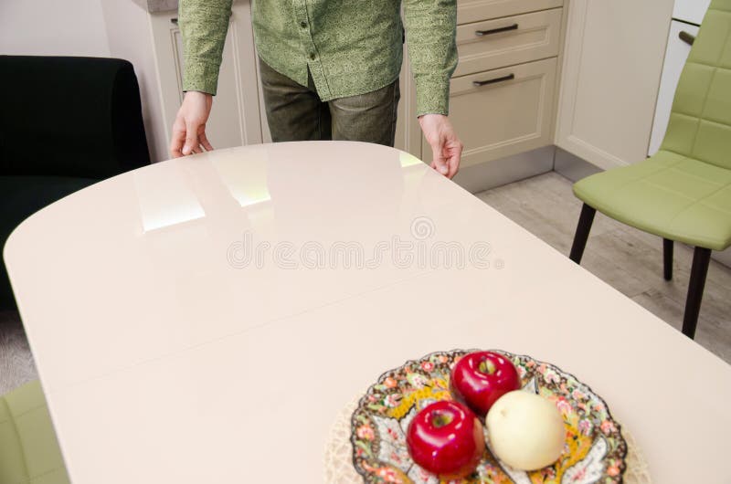 Man Shifts a Sliding Glossy Dining Table on Which Stands a Plate with ...