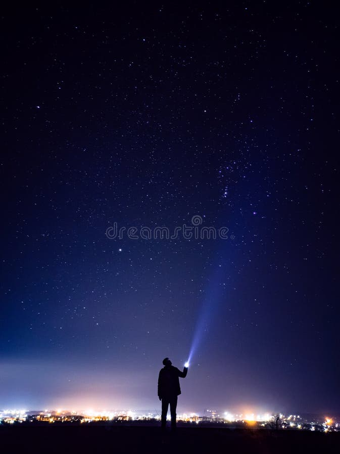A Man Shines a Flashlight on the Constellation Orion Stock Image ...