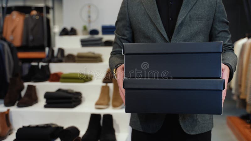 A Man with Shoe Boxes in Clothing Store Stock Footage - Video of store ...