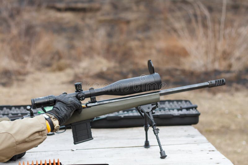 A Man Shoots a Rifle. Rifle Shooting with Optical Sight Outdoors by Man ...